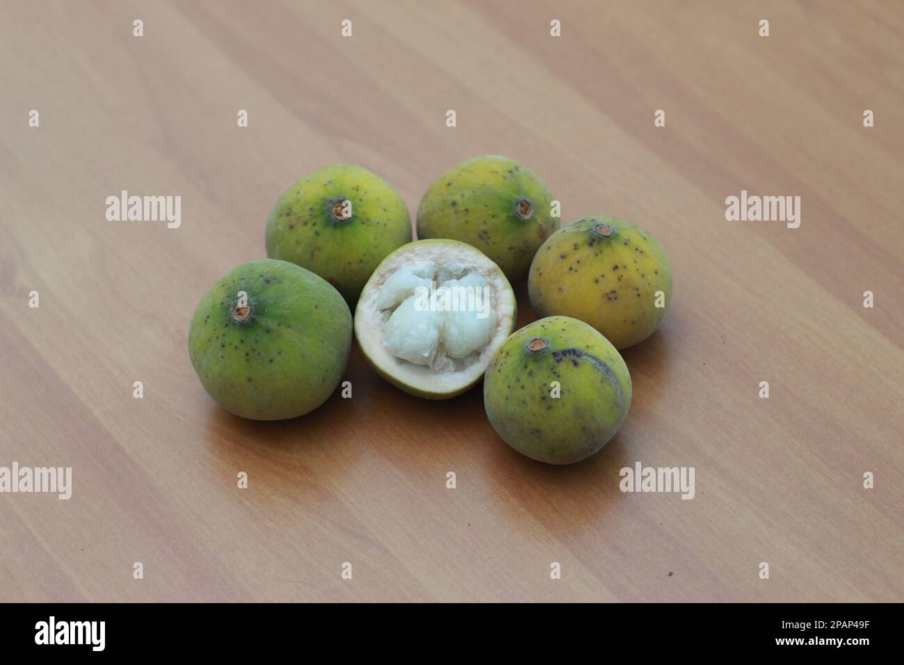 greenish yellow harp fruit isolated on money table has sweet and sour ...