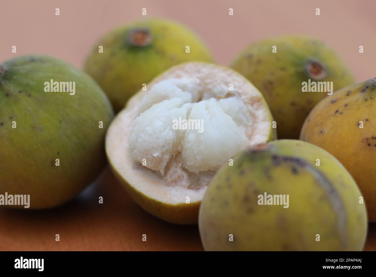 greenish yellow harp fruit isolated on money table has sweet and sour ...