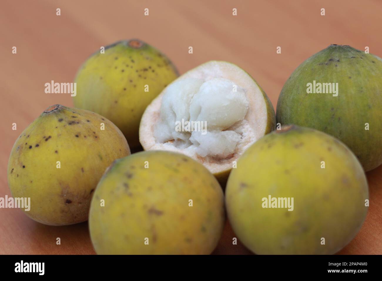 greenish yellow harp fruit isolated on money table has sweet and sour ...