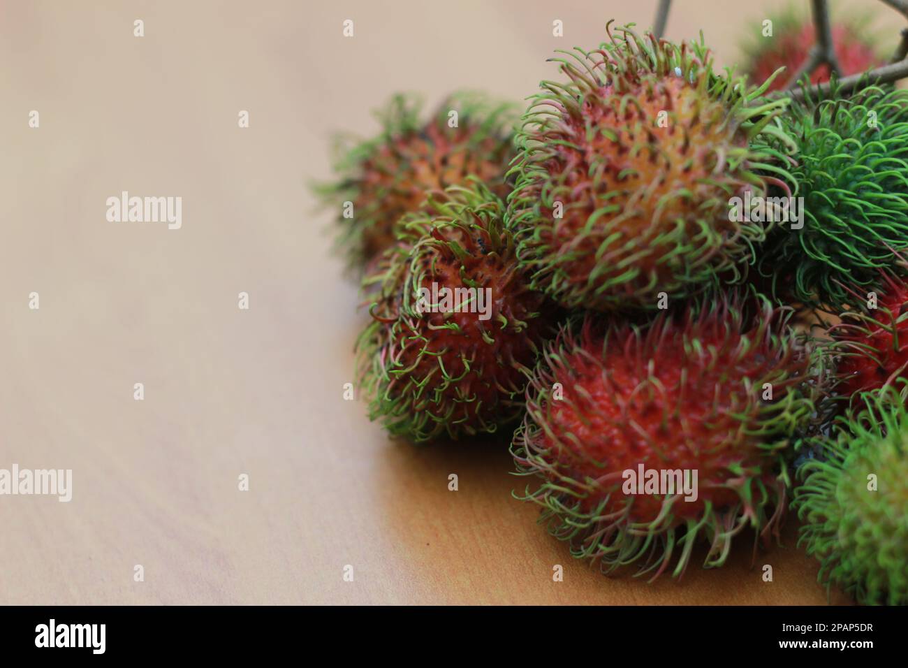 rambutan fruit which is reddish green in color having sweet taste ...