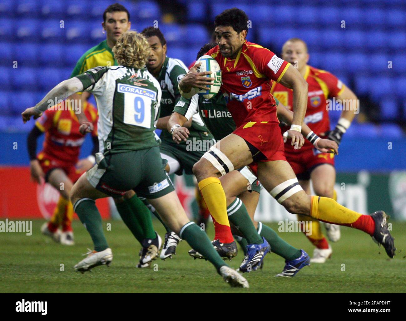 London Irish's Peter Richards, left, closes in on Perpignan's Viliami ...
