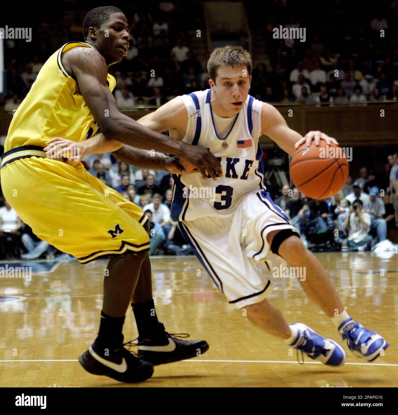 Duke's Greg Paulus (3) drives past Michigan's DeShawn Sims during the ...