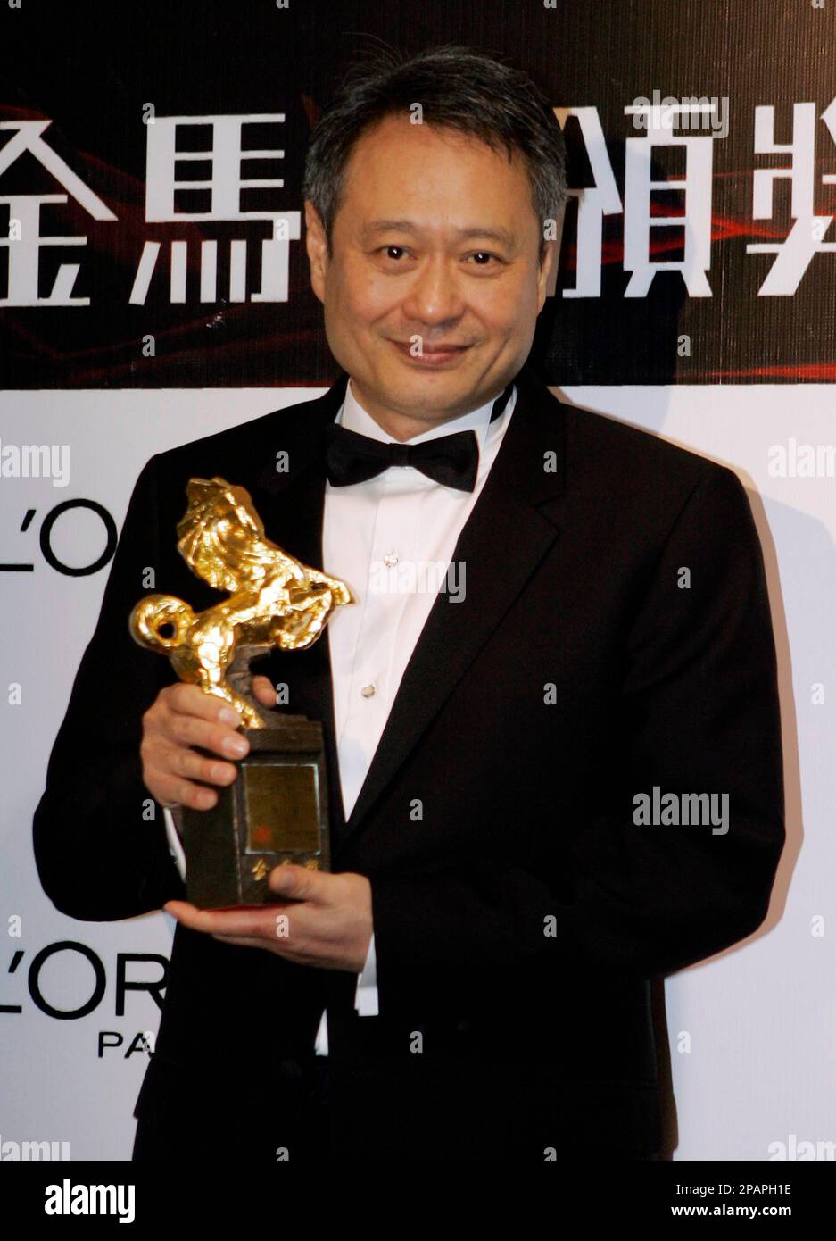 Taiwan director Ang Lee holds his award for the Outstanding Taiwanese ...