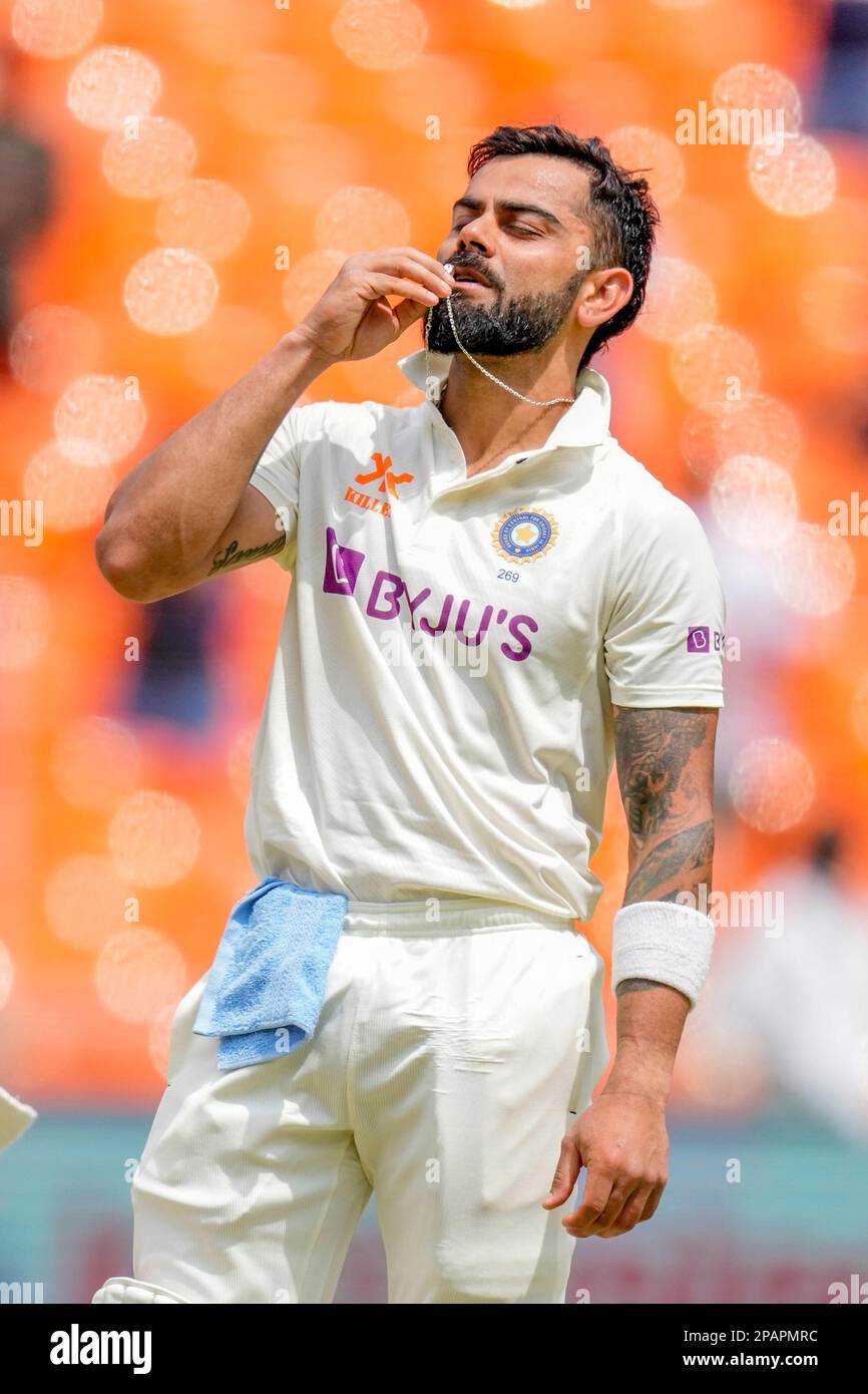 India's Virat Kohli kisses the locket as he celebrates scoring a ...