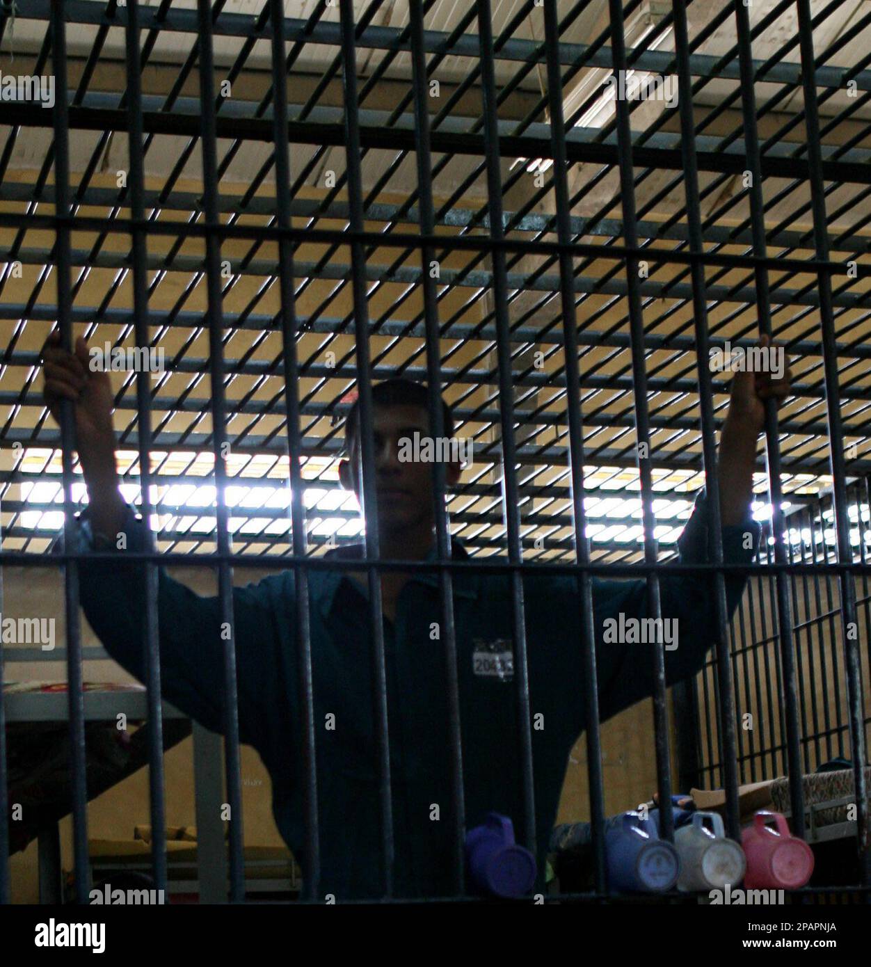 ** FILE ** Prisoner looks out of his cell in the Rusafa 5 intake prison ...
