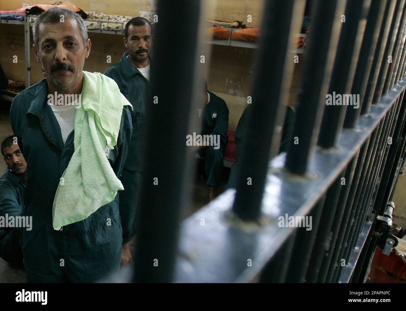 ** FILE ** Prisoners look out of their cell in the Rusafa 5 intake ...