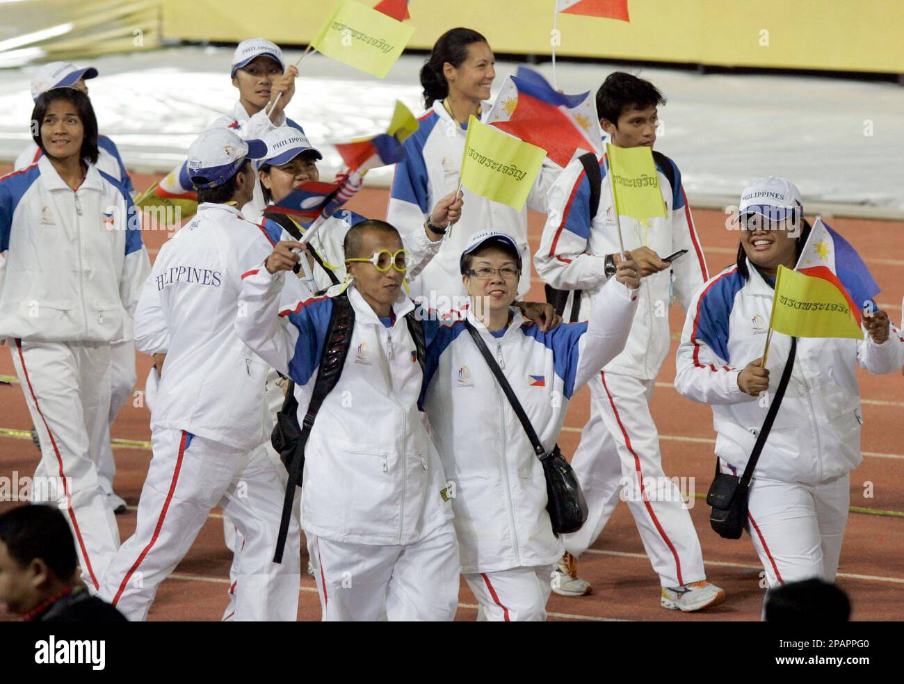 Athletes from the Philippines wave as they enter the main stadium ...