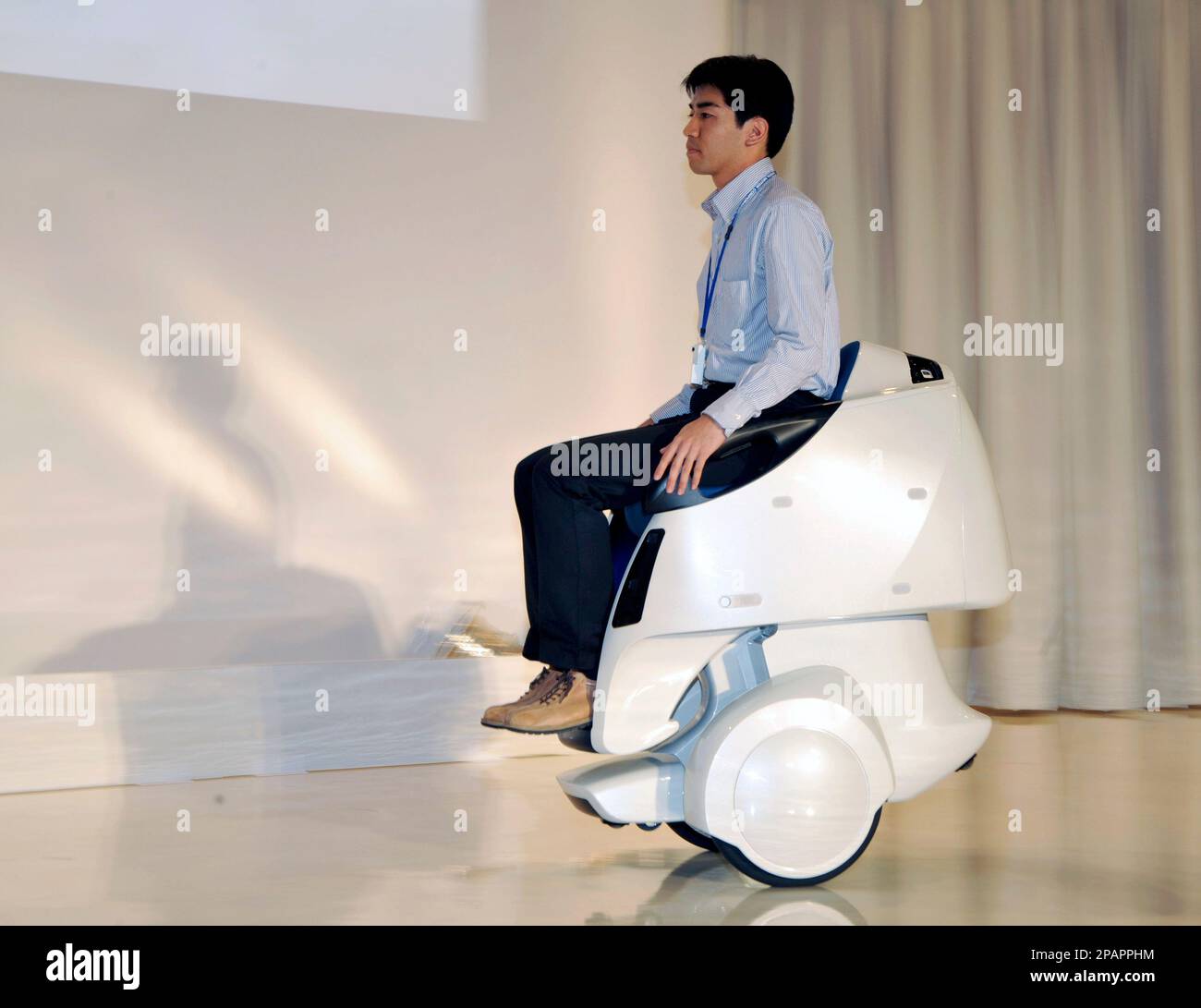 A Toyota Motor Corp. employee scoots around on the Japanese automaker's ...