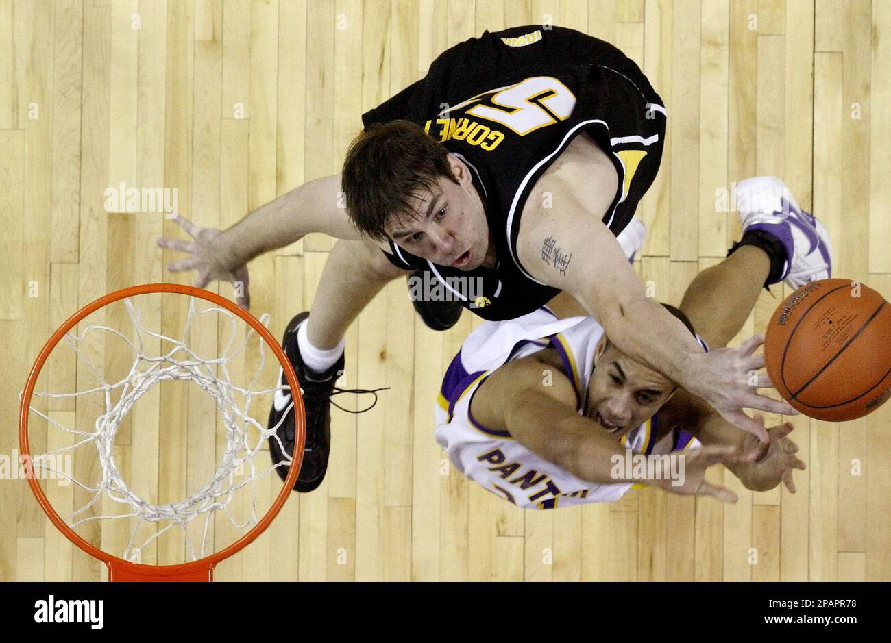 Iowa's Seth Gorney, left, blocks a shot by Northern Iowa's Travis Brown ...