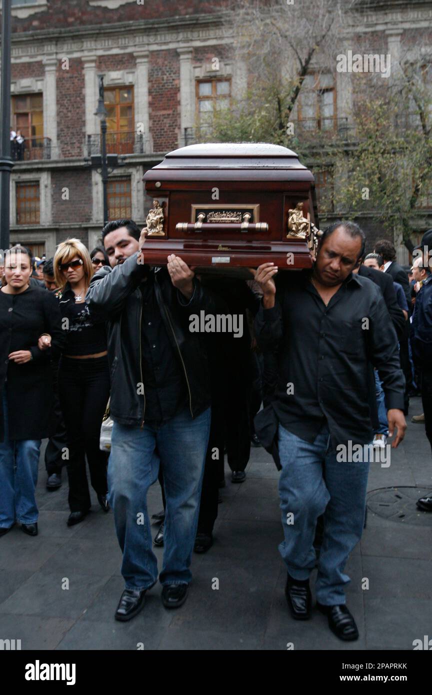 Band members and relatives carry the coffin containing the body of Sergio Gomez, the lead singer ...