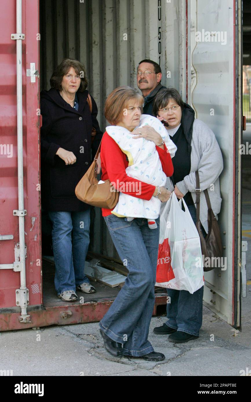 Shoppers at the Westroads Mall seek shelter in a metal container after ...