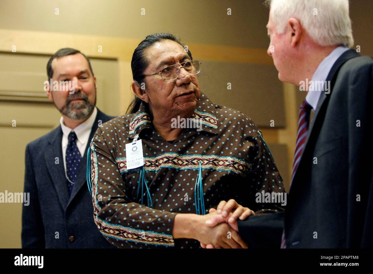 Sitting Bull's great-grandson Ernie LaPointe, center, shakes hands with ...