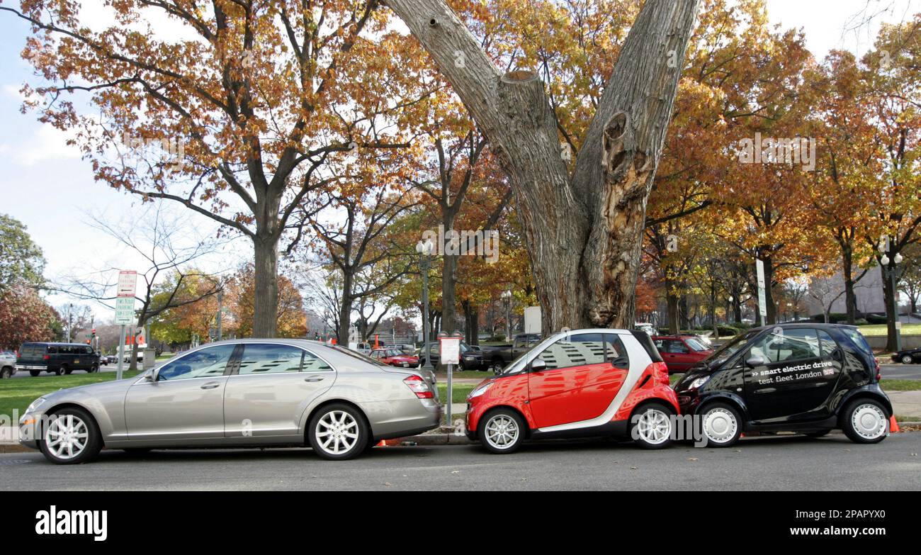 Two of Daimler AG's Fortwo new smart cars, right, are shown parked in ...