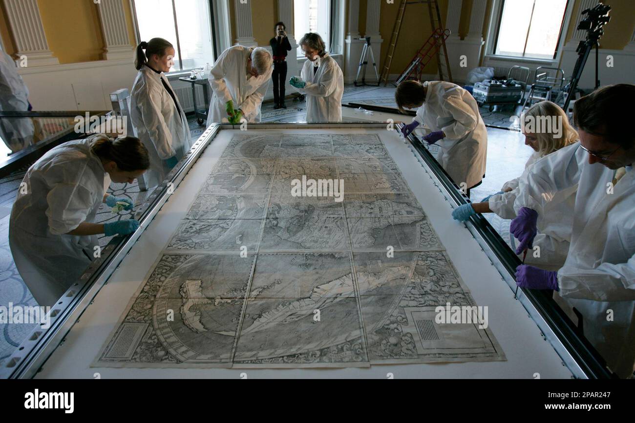 Conservators at the Library of Congress in Washington clean and ...