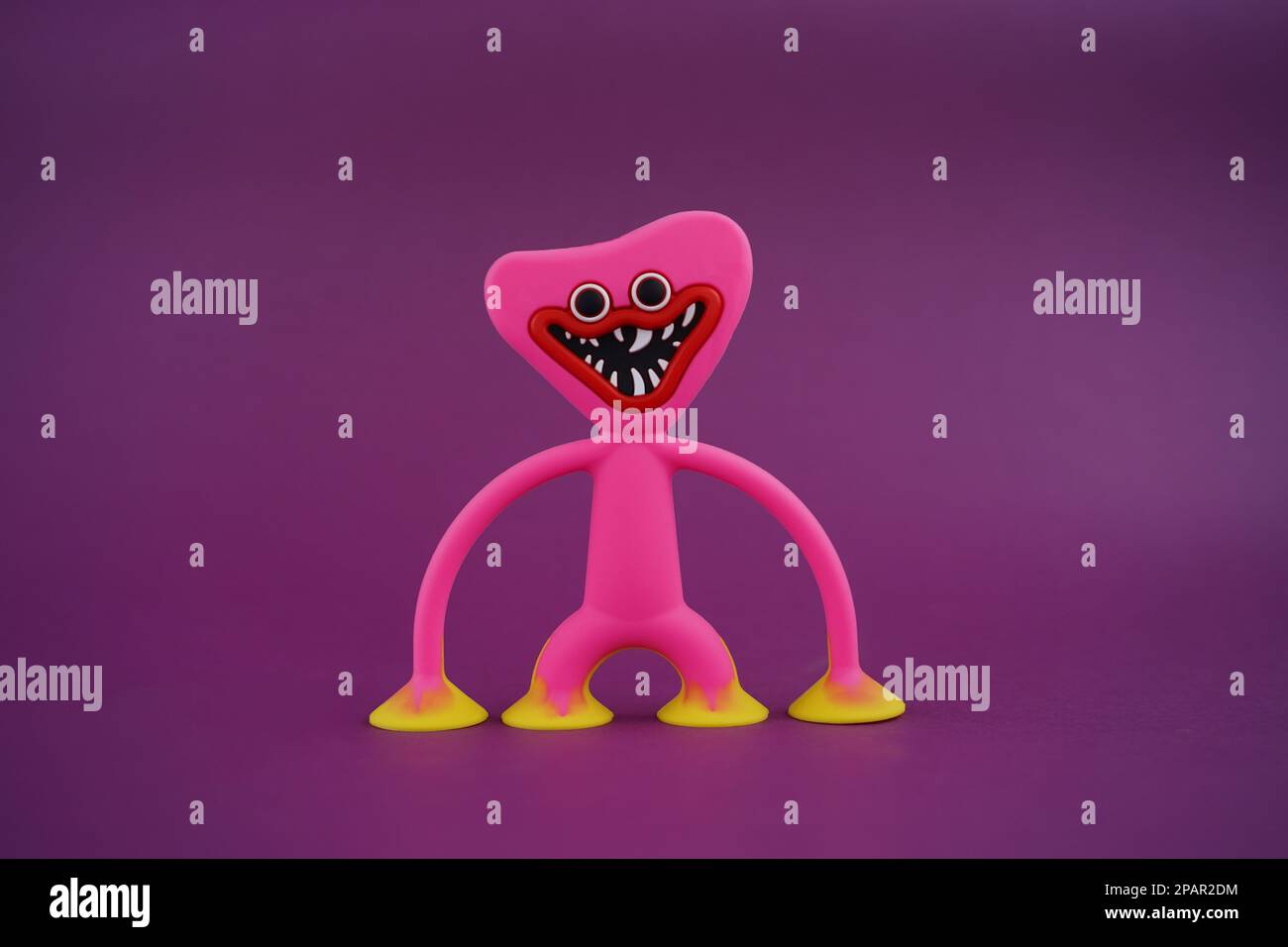 Pink monster chef holding on to the ground on viva magenta background ...