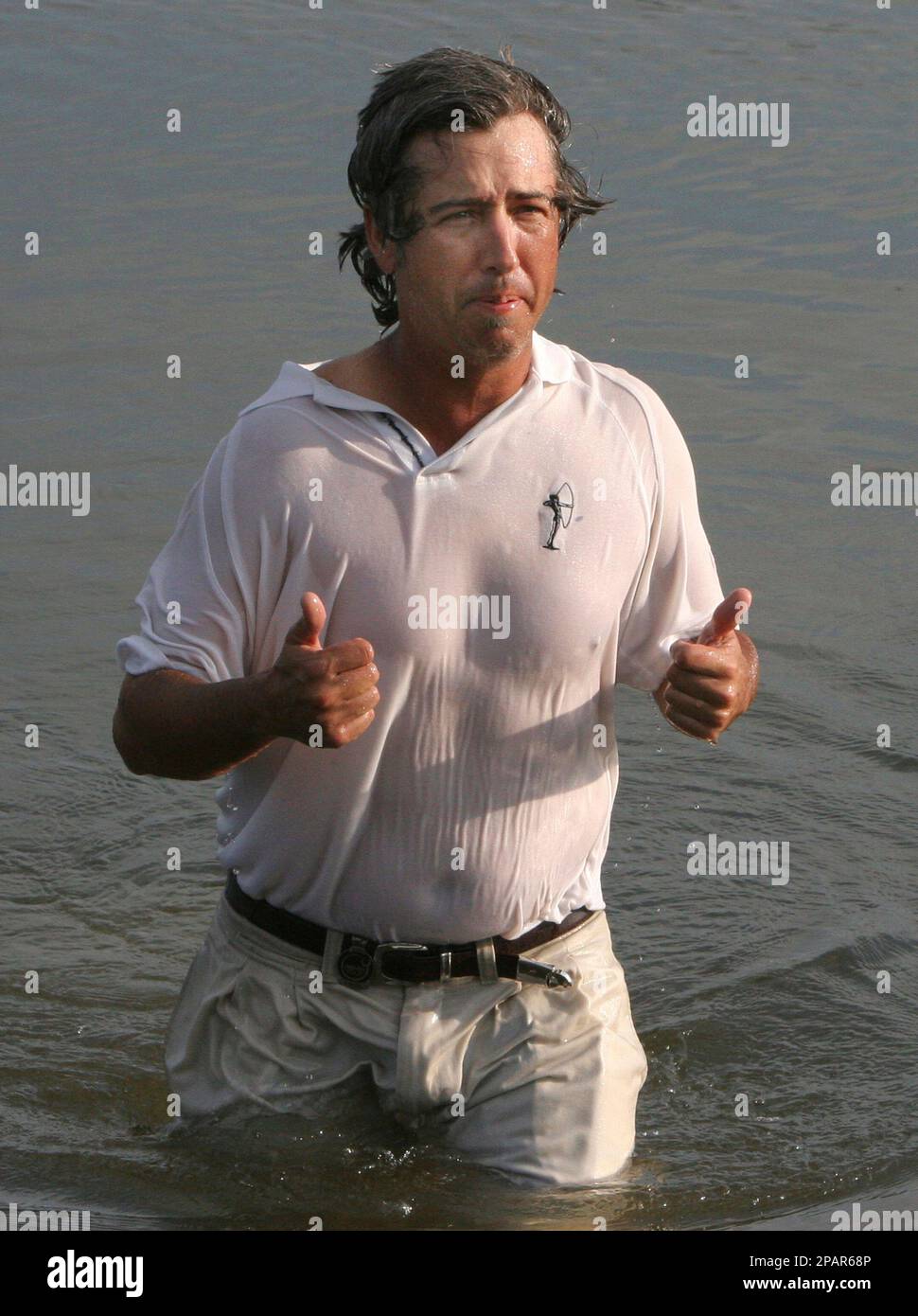 Bryan Saltus of the U.S. reacts after jumping into water in celebration ...
