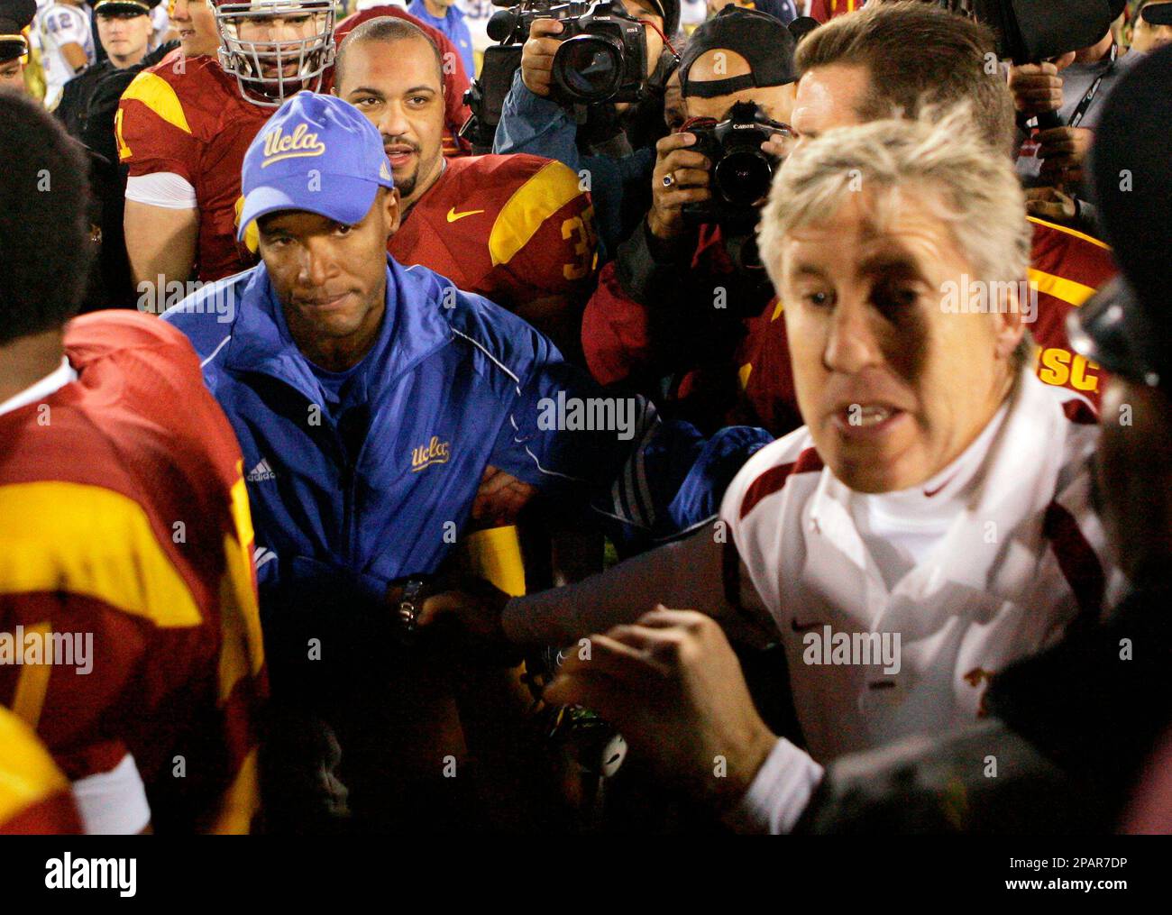 UCLA head coach Karl Dorrell, left, shakes hands with Southern ...