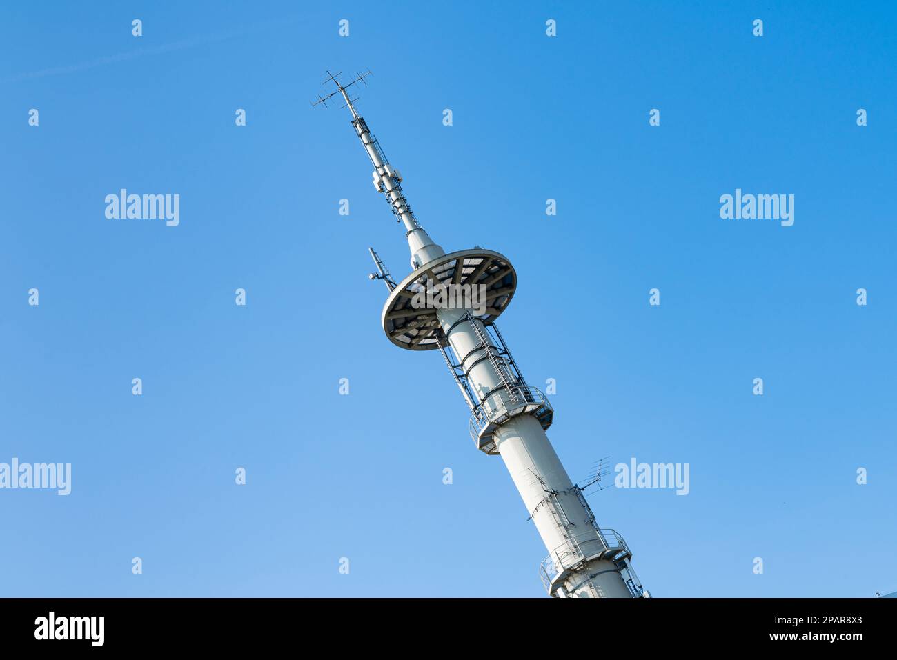 Radio broadcasting tower with an antenna against the blue sky Stock Photo - Alamy