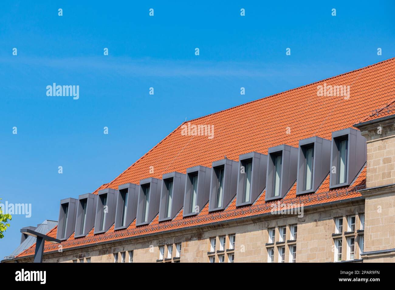 Dormer windows with tides in a house with a tiled roof. Against the ...