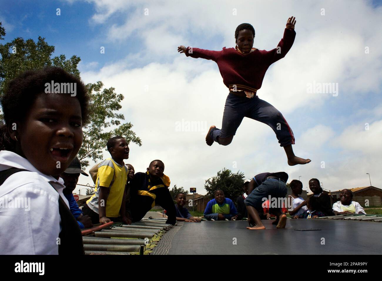 Children play on a trampoline in the Dobsonville area of Soweto, South ...