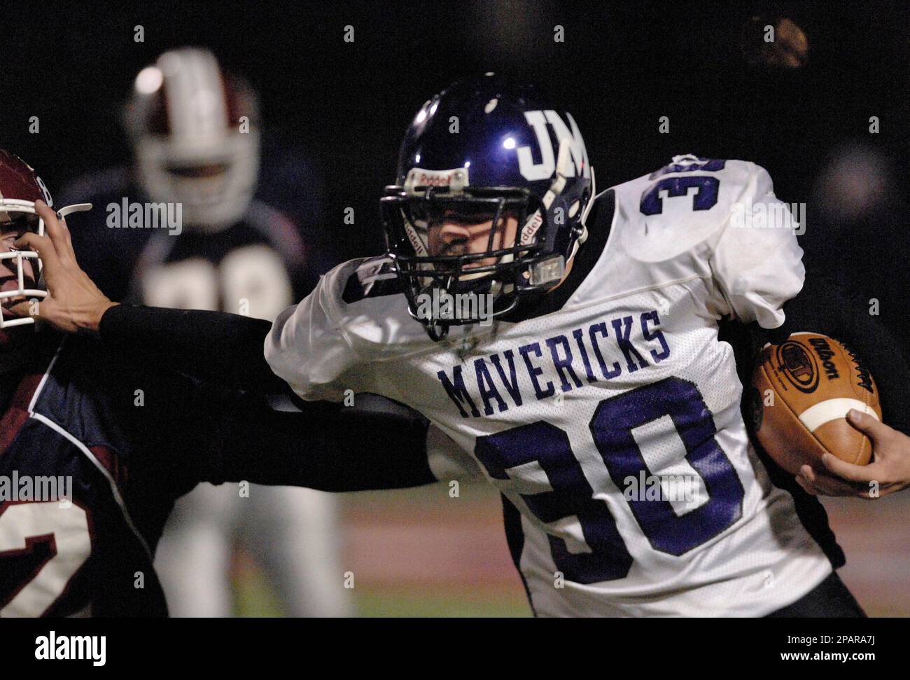 James Monroe's Ernie Tincher (30) stiff-arms Bluefield's Jacob Lilly ...