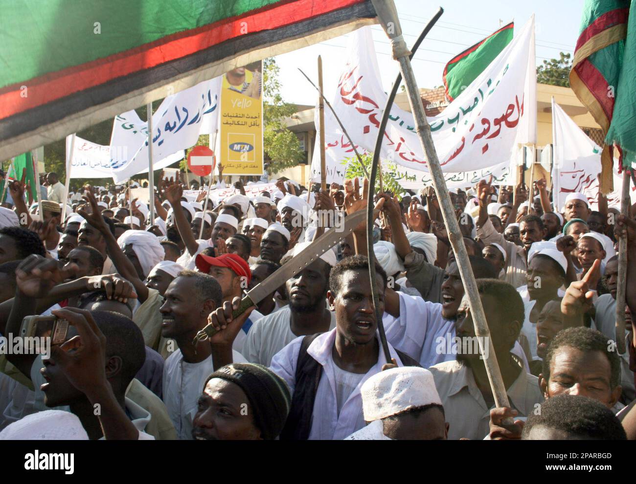 Thousands of Sudanese, many carrying swords, knives and sticks, protest ...