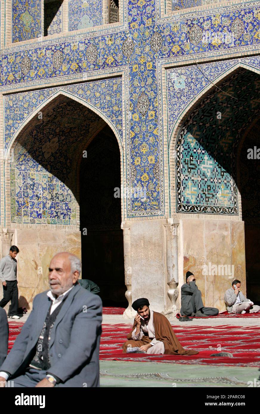 An Iranian Shiite Cleric speaks on his cellphone, before traditional ...