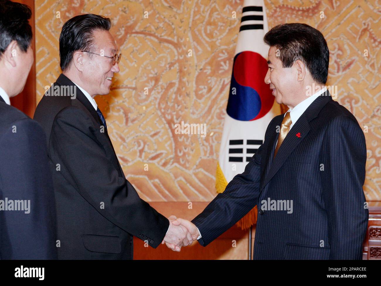 South Korean President Roh Moo-hyun, right, shakes hands with North ...