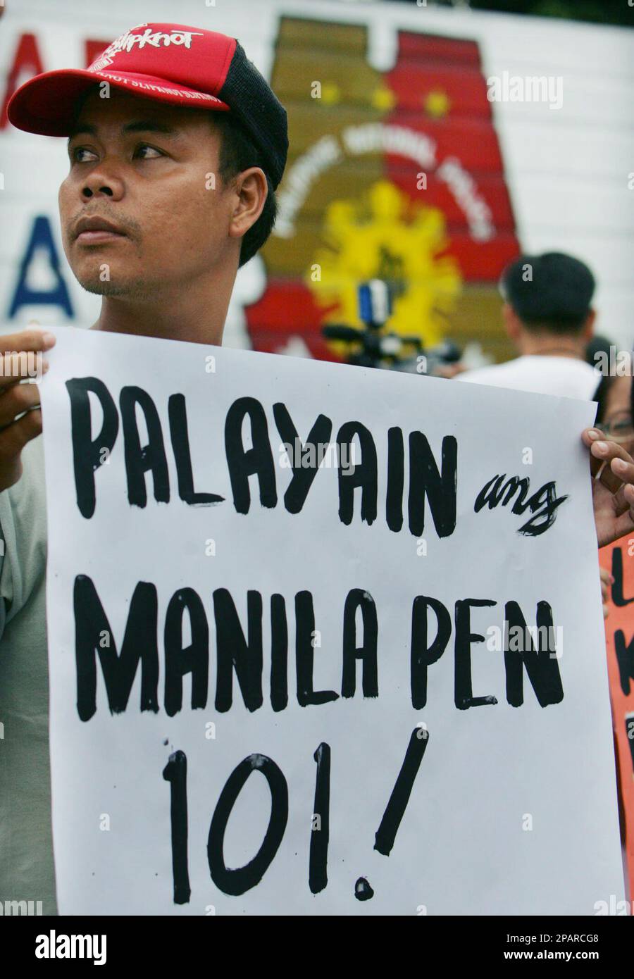 A protester displays a placard calling for the release of all those ...