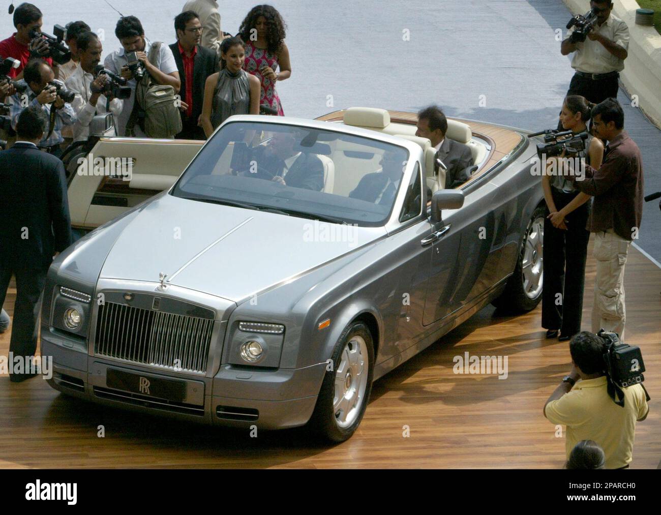 Journalists view the Rolls-Royce Phantom Drophead Coupe at its launch ...