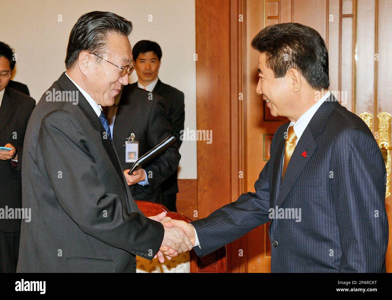 South Korean President Roh Moo-hyun, right, shakes hands with North ...
