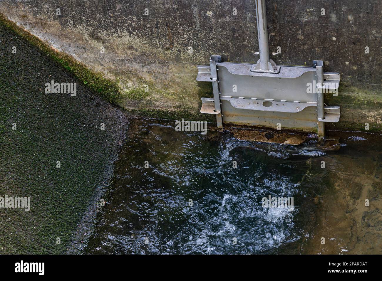 The water flows through the floodgates. Small metal gate valve Stock ...