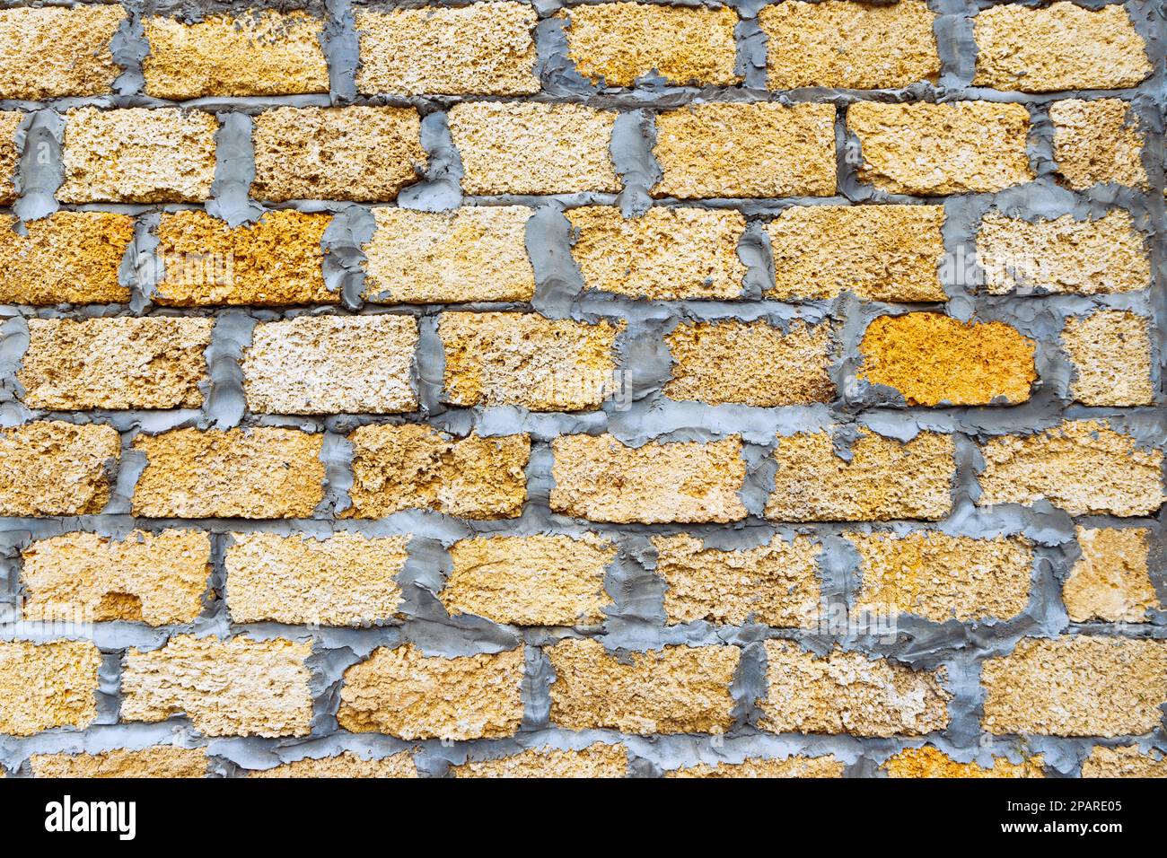 Stone bricks from limestone laid, cement, yellow brown background ...