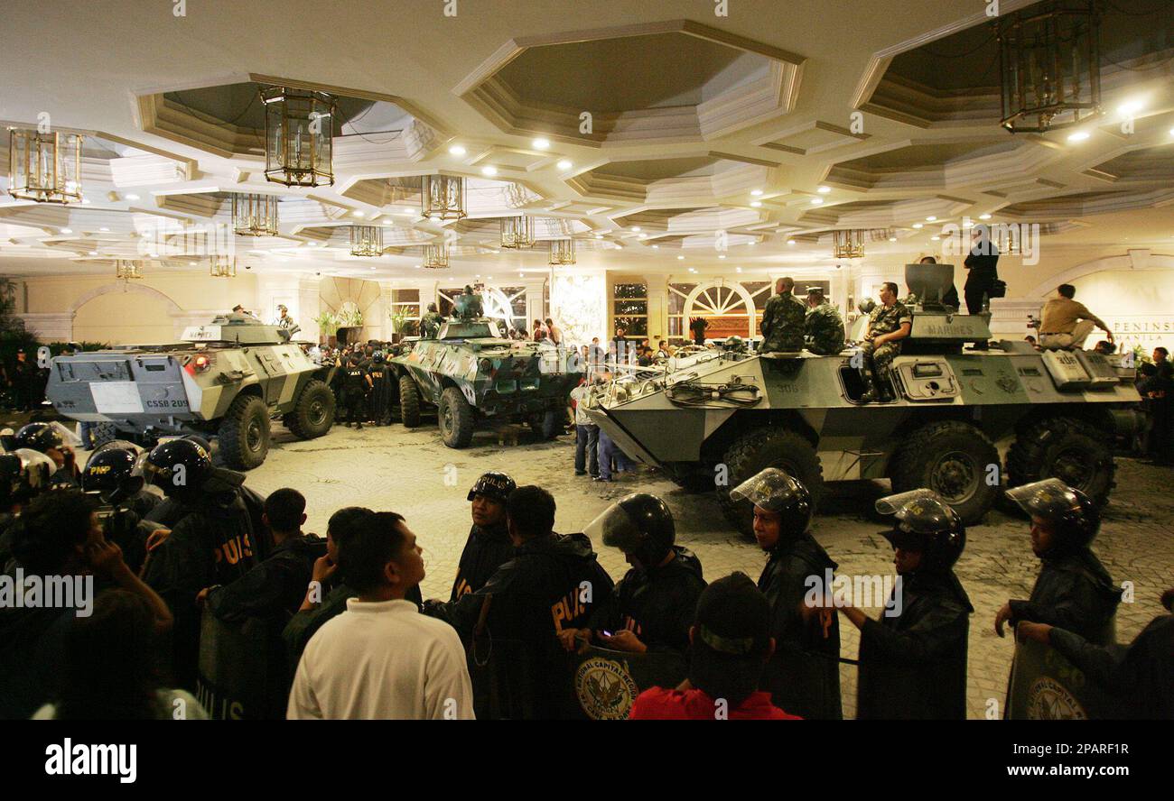 Armored Personnel Carriers are seen at the main entrance of the Manila ...