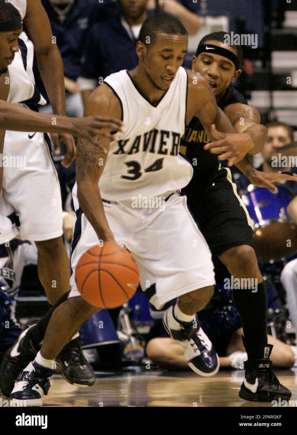 Xavier guard Stanley Burrell (34) steals the ball from Oakland forward ...