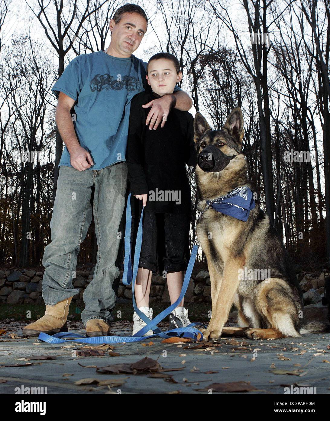 Guy James stands with son Ben James, 9, and their pet German shepherd ...