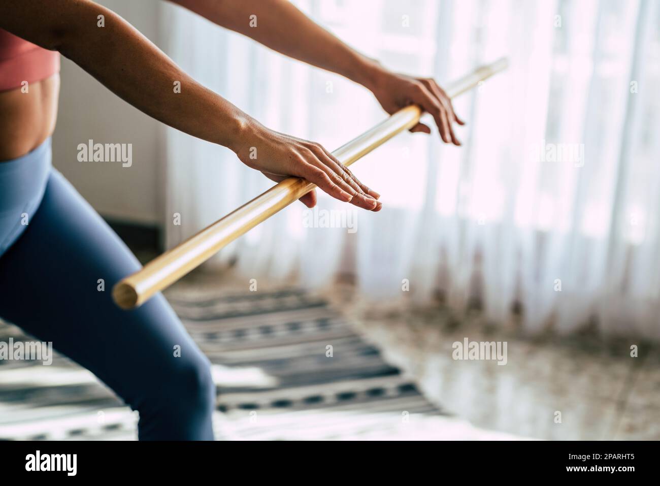 Close up of woman hands doing pilates and gym sport exercises at home ...