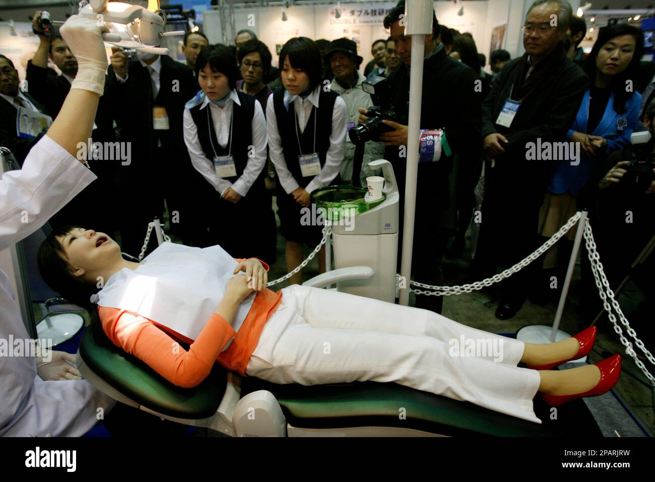 A humanoid robot has her teeth checked by a dentist at Japan's largest ...
