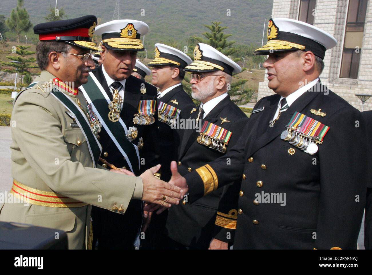 Pakistan’s President Gen. Pervez Musharraf, left, shakes hands with ...