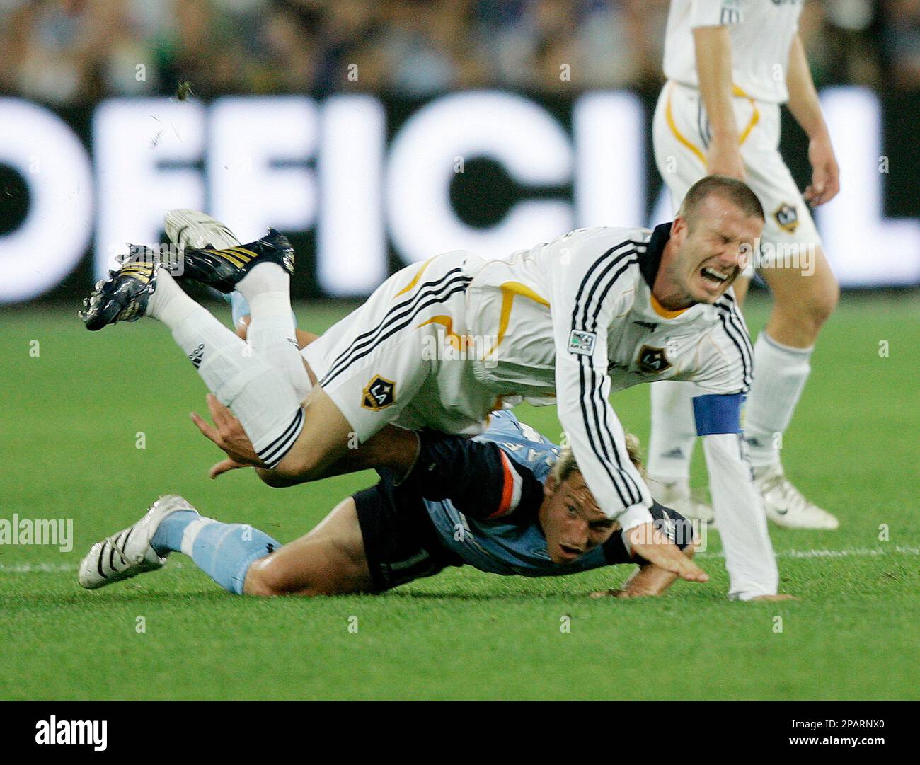 English soccer star David Beckham, top, grimaces as he is tackled ...