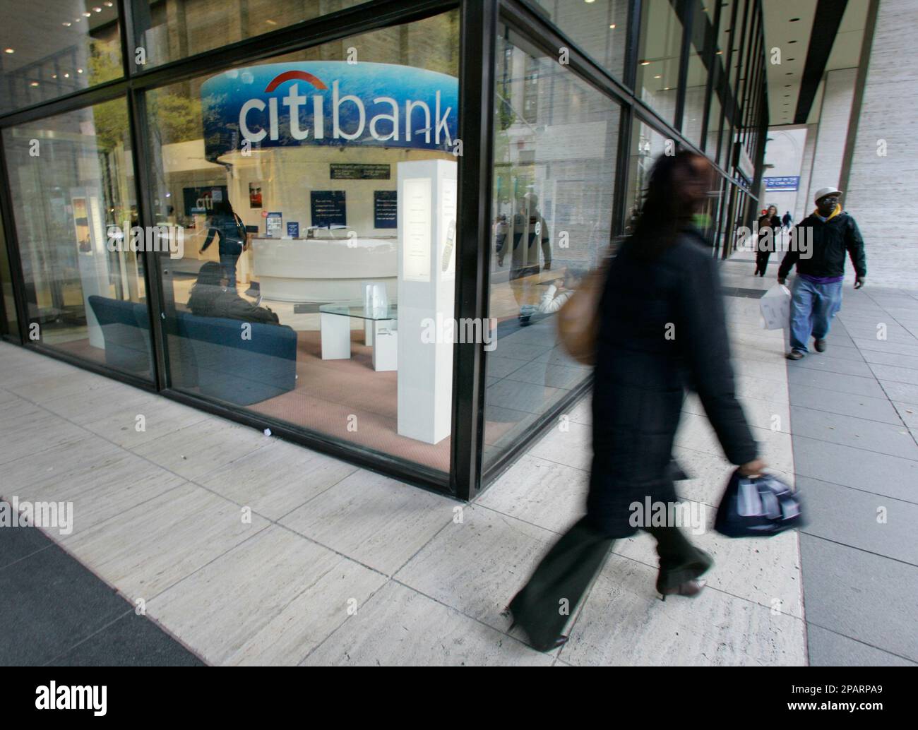 ** FILE ** Pedestrians pass a Citibank branch office in this Monday ...