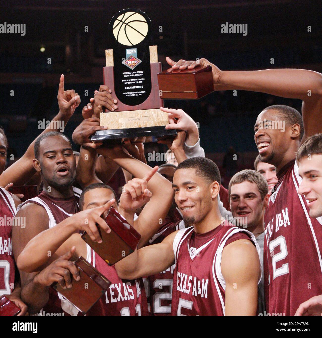 Texas A&M players hold up the championship trophy after beating Ohio ...