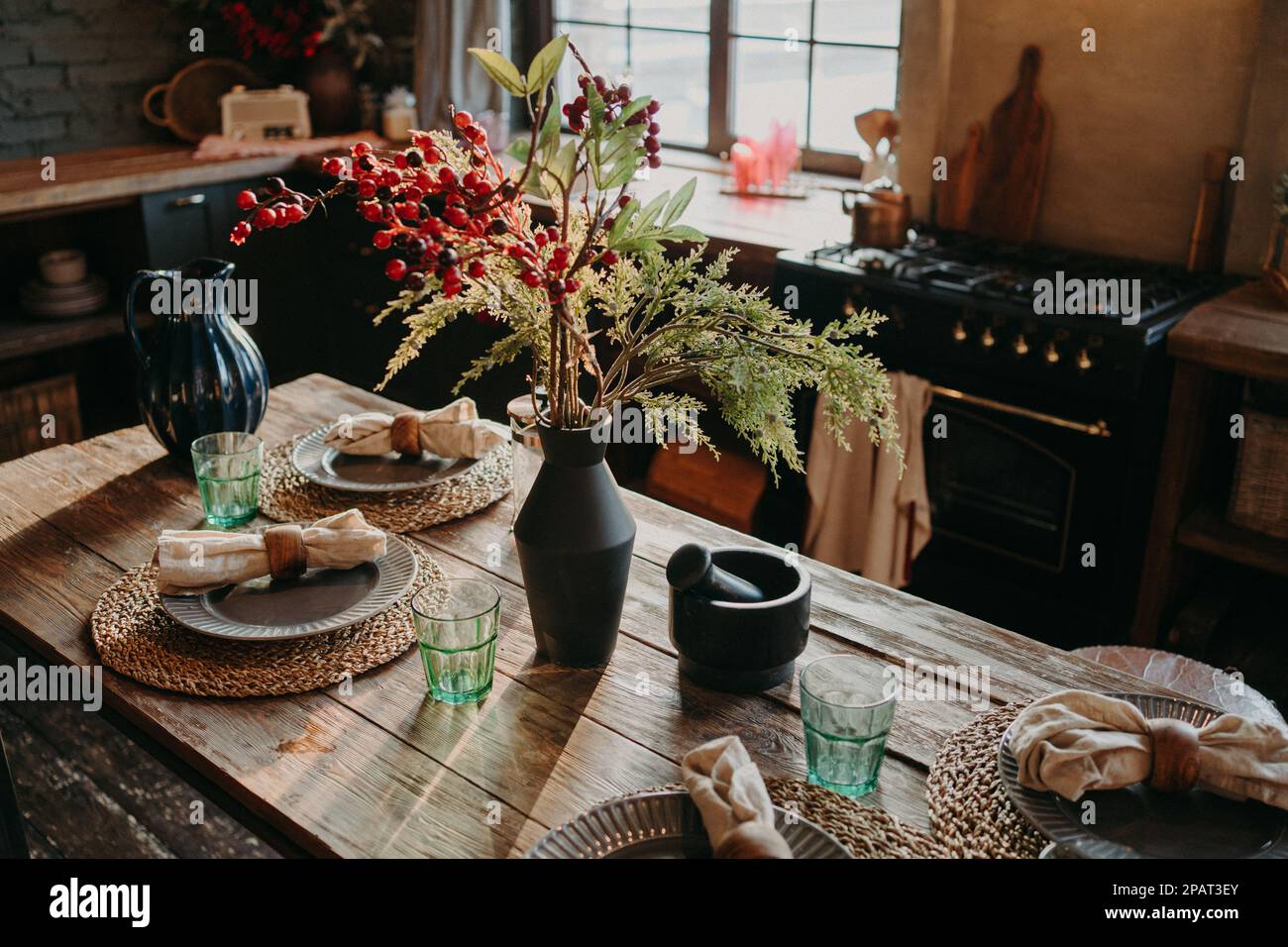 Served nicely decorated dining table with plates napkins vase. Kitchen ...