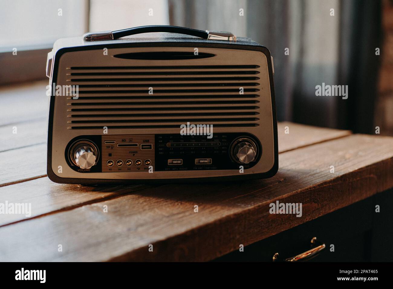 Radio broadcasting music. Old retro radio in light room on wooden table ...