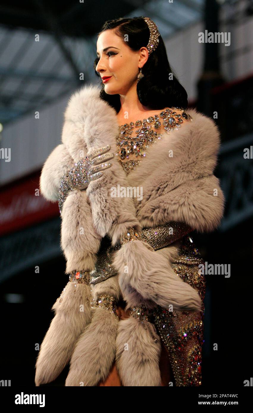 Dita Von Teese, the U.S. burlesque artist poses on stage for ...