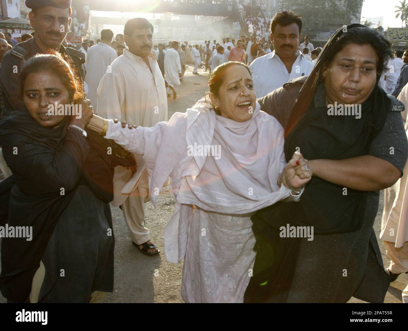 Police officers arrest a political activist during a rally against ...