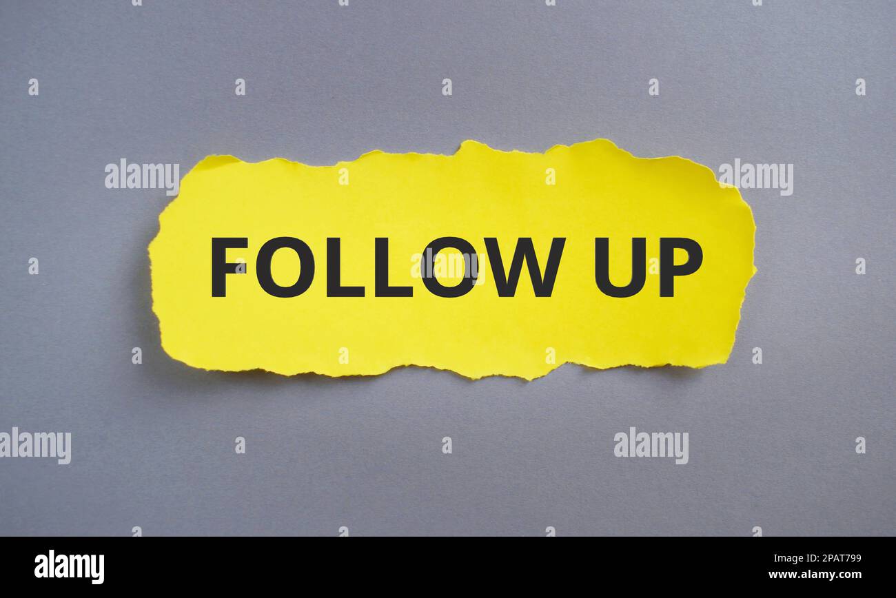 Mock up with torn paper FOLLOW UP text. sheet of yellow paper on a grey ...