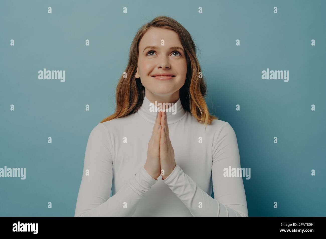 Headshot portrait of happy young woman looking up making wish while ...