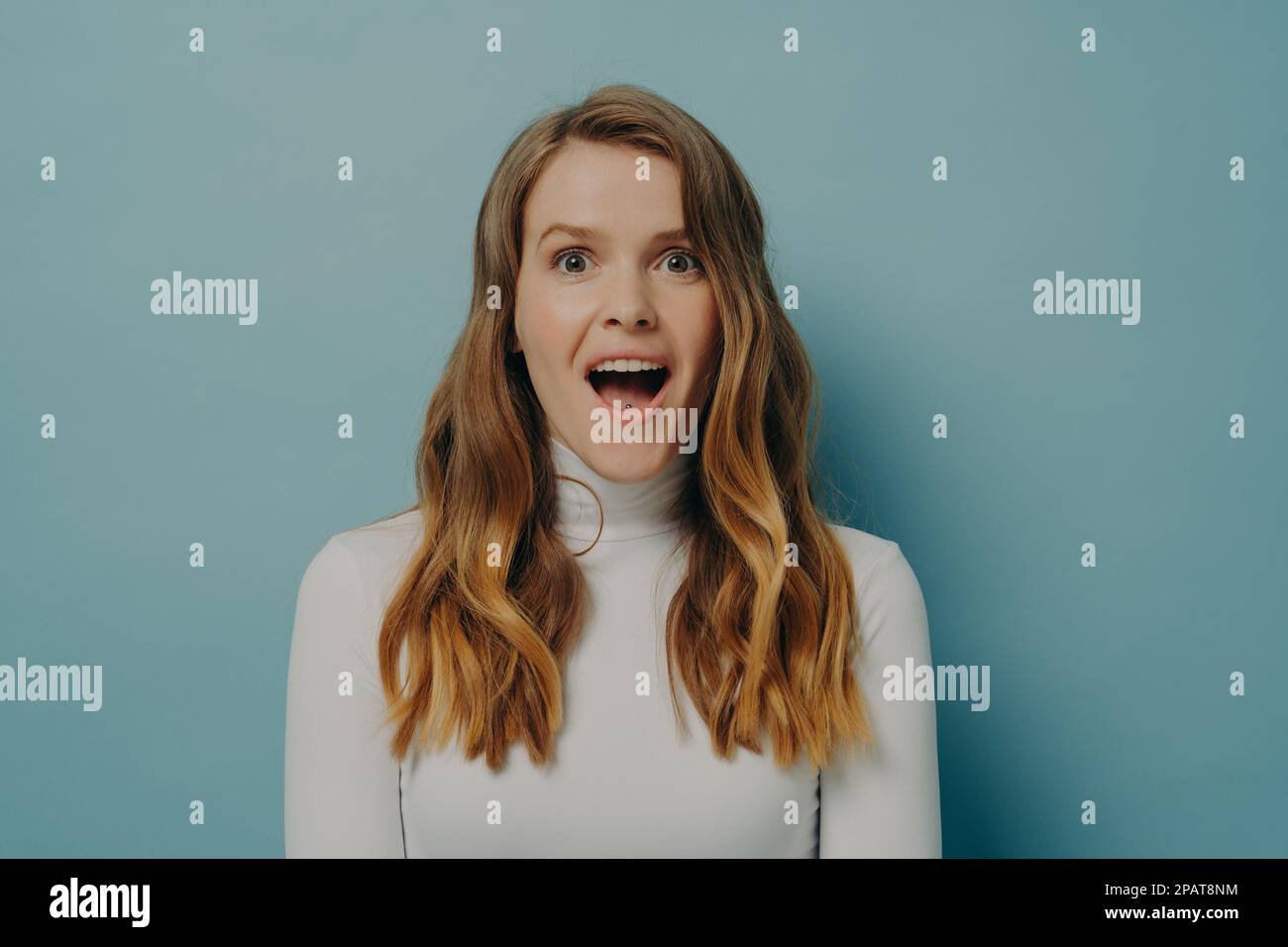 Positive pretty young woman with surprised shocked funny facial ...