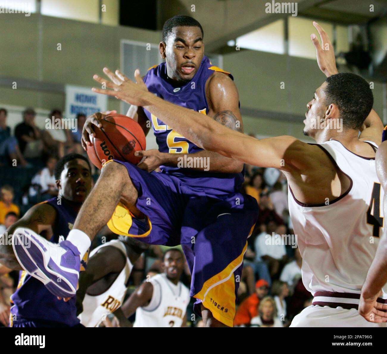 Louisiana State's Marcus Thornton, left, grabs a rebound in front of ...